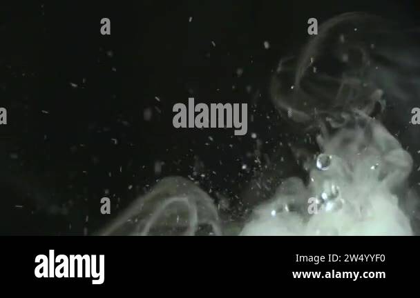 Chemical reaction with boiling swirling water splashes, jumping drops ...