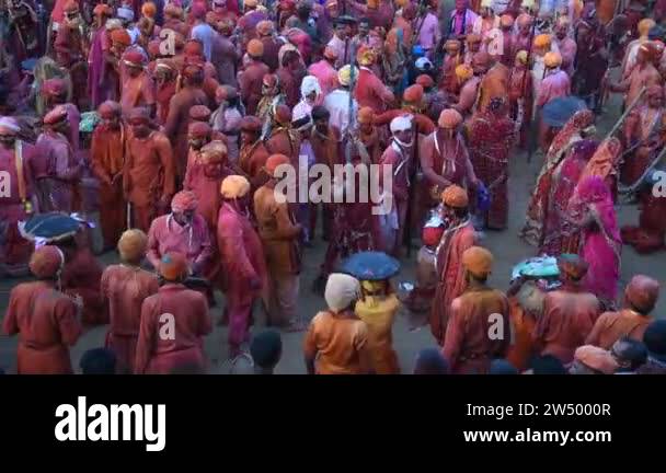 Women beat up men with long sticks as a ritual in the Lathmar Holi ...