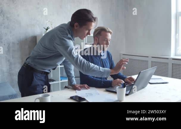 Two business persons are work together in modern office. Team of ...