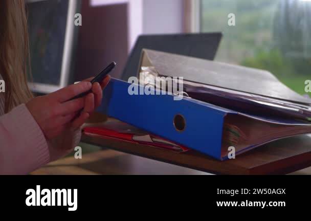 Busy woman with files and folders on messy desk using smartphone Stock ...