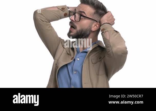 angry young guy holding hand behind head, furiously screaming, making ...