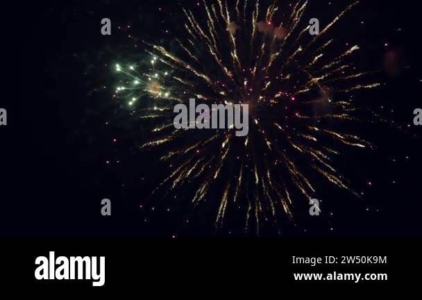 shining fireworks with bokeh lights in the night sky. glowing fireworks ...