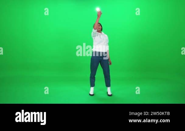 African woman dancing at a music concert, woman holding smartphone with ...