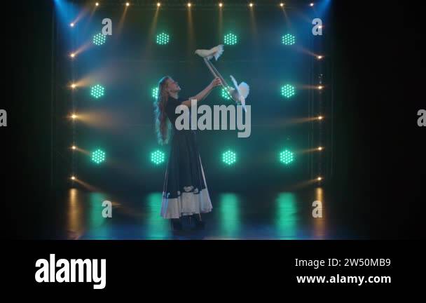 Performance of trained white doves. Pretty woman with long wavy hair in ...