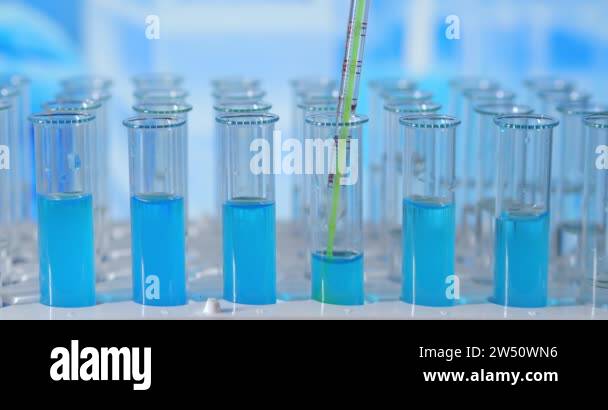 scientist with a pipette analyzes a liquid to extract the DNA and ...