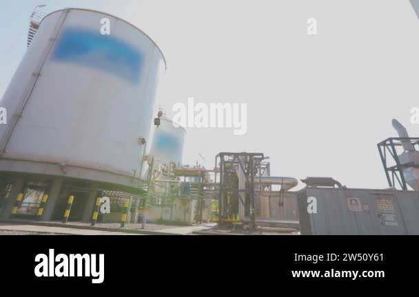 White storage tanks for liquids in a modern factory. Large storage ...