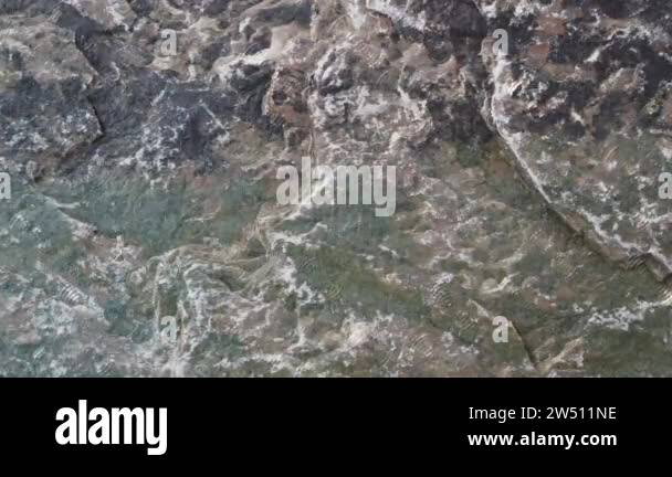 rain drop on mineral and hard heavy granite stone surface of cave for ...