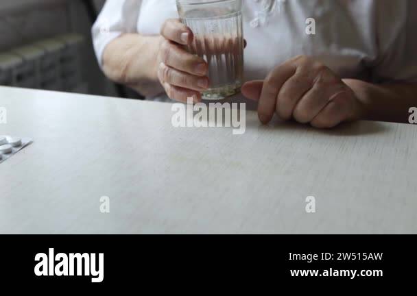 Sad old woman taking pills, health problems in old age, expensive ...