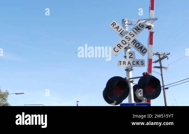 Level crossing warning signal in USA. Crossbuck notice and red traffic ...