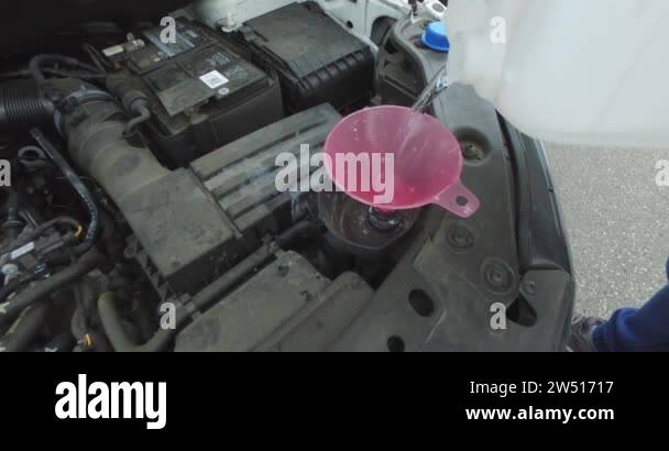 Pouring exhaust additives for diesel engines into the tank for adBlue ...