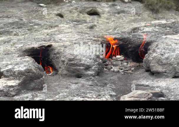 Flame of Methane Underground Emerges From Crack Between Rocks and Burns ...