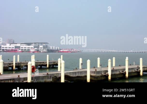 Mooring posts at Macau Fishermans Wharf and view of Outer Harbour Ferry ...
