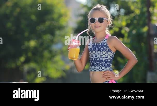 Beautiful little girl, cute toddler in swimwear with sunglasses is ...