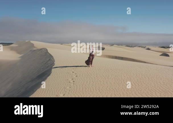 Woman making hand gestures creating painting art outdoors in sand desert 4K shot Stock Video ...