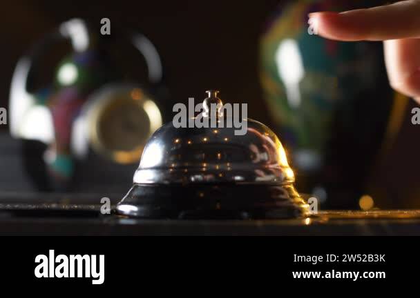 Female ringing the bell in a hotel lobby. Close-up. 4K resolution, slow ...
