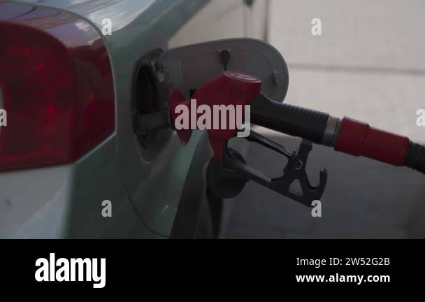 Close up of car refueling at gas station service. Open car fuel tank ...