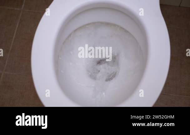 Toilet Flushed Top Down View. Water and Paper Flushing Down into Toilet ...