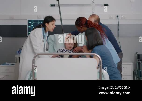 Pediatrician woman doctor holding sick little child monitoring disease ...