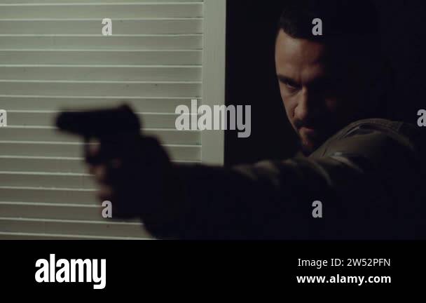 Man shooting a gun. Russian handgun PMM Makarov. Serious killer shoot a ...