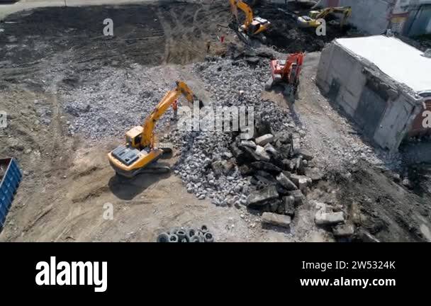 Dismantling work at the construction site. Excavators with a hydraulic ...