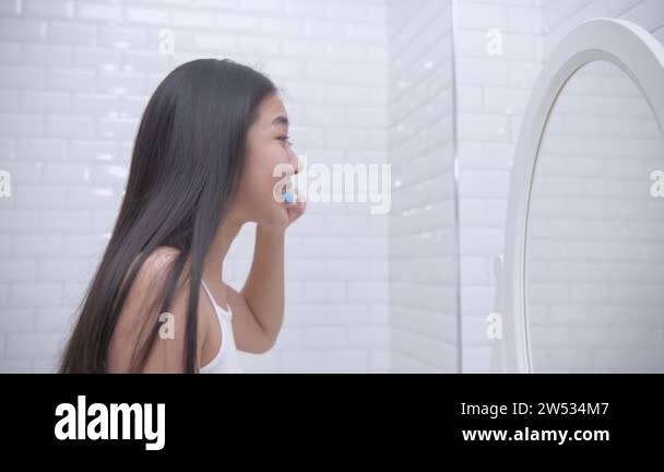Daily routine concept of 4k Resolution. Asian woman brushing teeth in ...