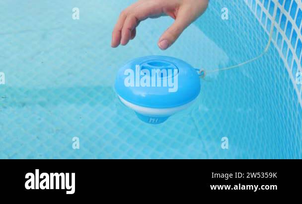 Worker hands isinfection and chlorination of water in the pool ...