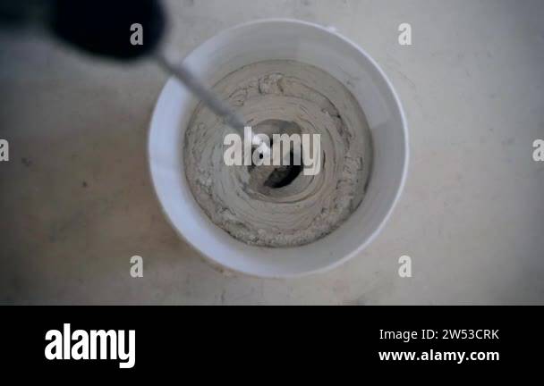 Process mixing adhesive solution in large white bucket using ...