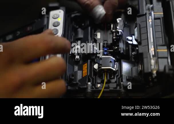 Worker welds optical line internet wire with welding machine. Service ...