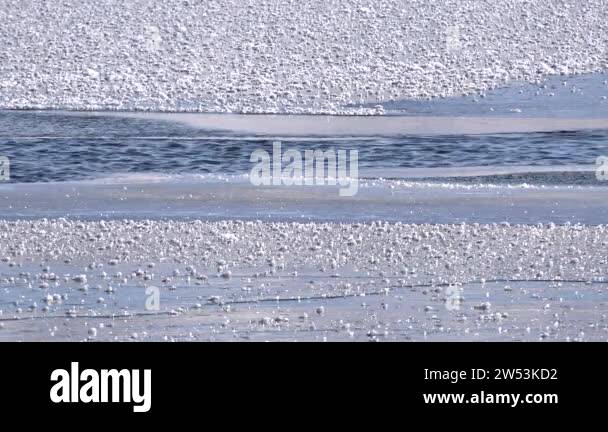 Little Stream Water Flowing on Ice.Frozen water surface of the dam lake ...