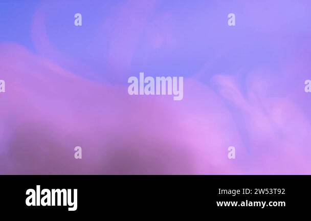 Pink fog against the sky. Smoke on a blue background. Magic clouds, a ...