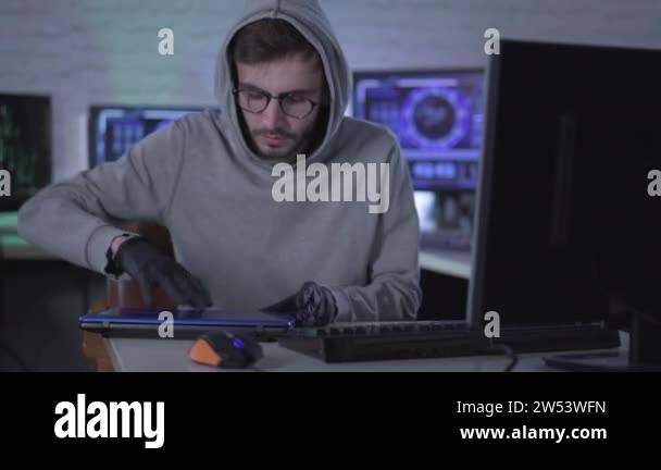 Confident serious man entering office with multiple computers, opening ...
