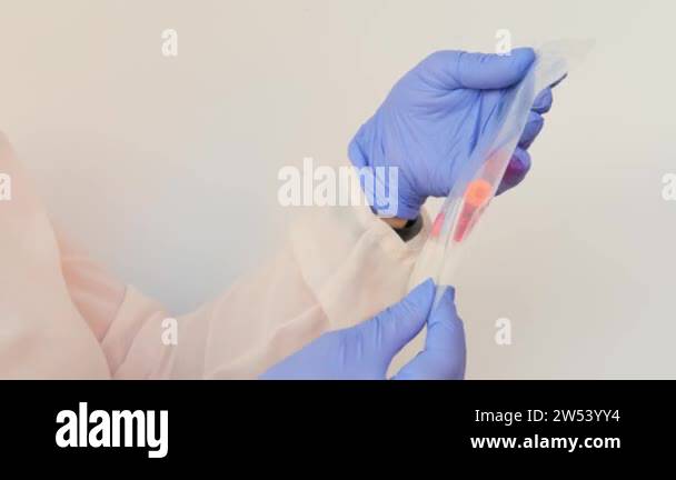 girl holds a kit for a dna test in a box, a cotton swab for scraping ...