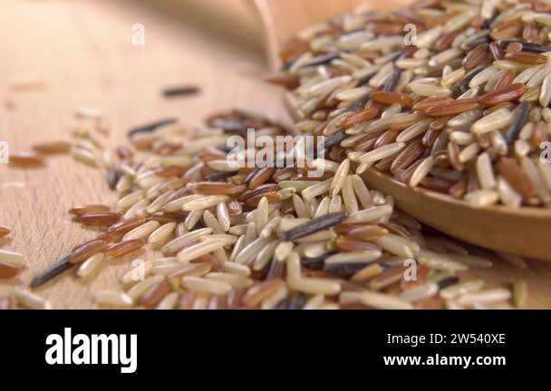 Basmati rice mix in a wooden spoon on a board. Macro. Mixed asian ...
