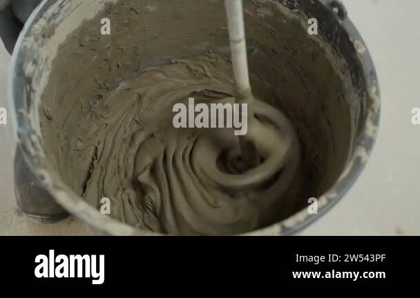 Mixing of dry building mixes with mixers. Wet mortar mixture for ...
