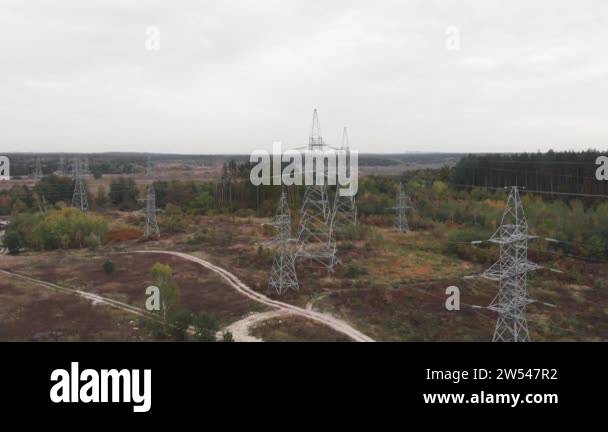 Transmission electricity steel pylon towers in forest. Green energy ...