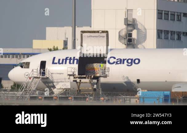 Airfreighter being unloaded on the apron of cargo terminal Stock Video ...