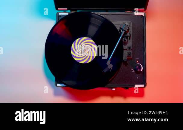 Music retro turntable with a spinning vinyl record against a backdrop ...
