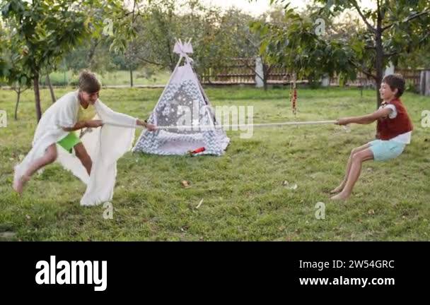 Two Boys Pulling Rope. They Compete For Who Is Stronger. Children In ...