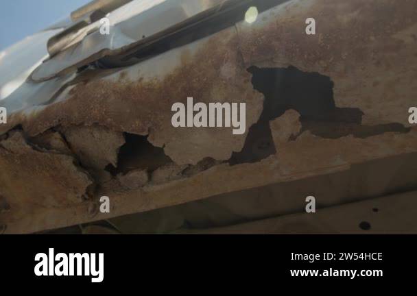 Deep rust on the body of a gray old car. Rust and corrosion hole on old ...