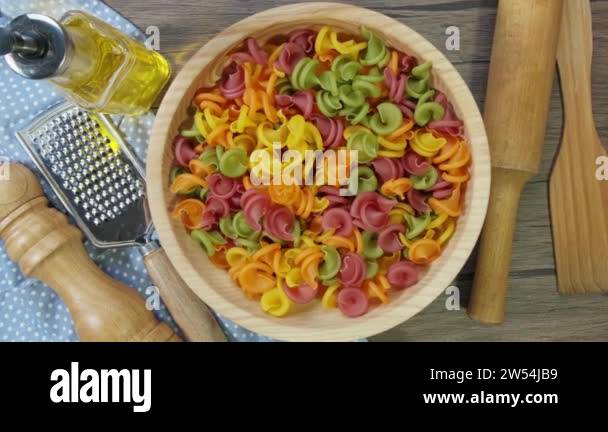 Multicolored Pasta rotating in slow motion top view. Rotation of ...