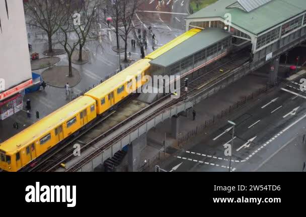 Yellow Public Transport Train exiting Subway Station elevated above ...