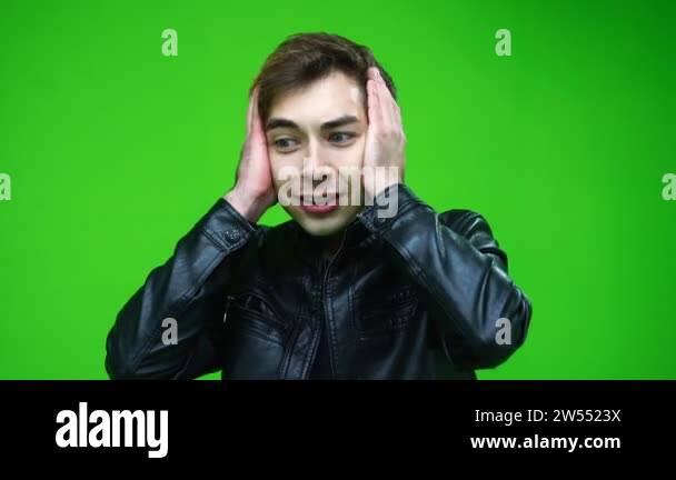 White man in leather jacket holding his head in panic or stress over ...