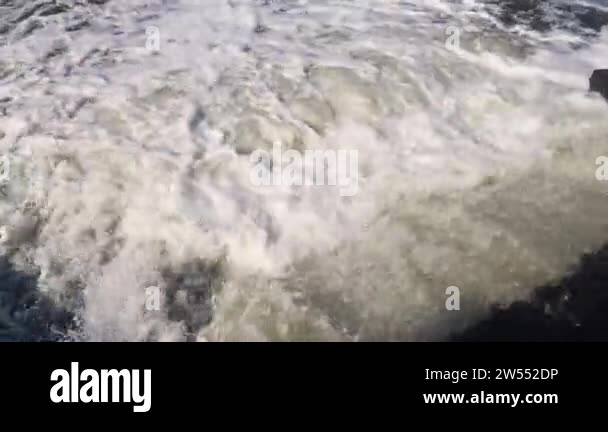 Water pollution. Dirty water from treatment plants flows through a pipe ...