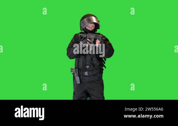 Counter terrorist soldier in armor standing and reloading machine gun ...