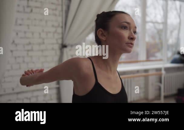 Cute girl stretches her arms, shoulders and neck before starting a ...