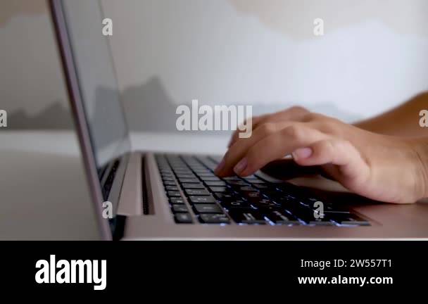 White female hands typing fast on a laptop keyboard. Ten finger blind ...
