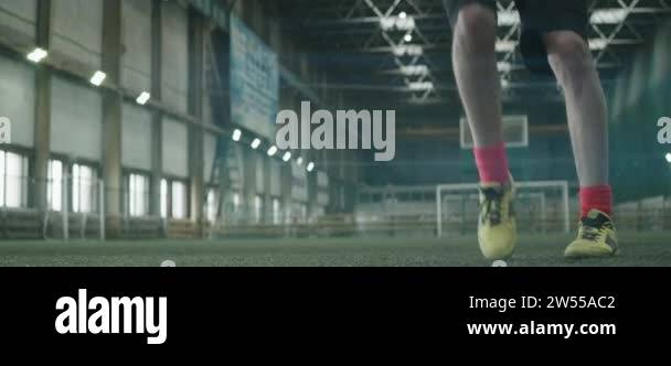 Low section anamorphic shot of legs of professional male soccer player ...