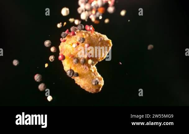 Seasoned Chicken Nugget with Salt and Pepper Flying in the Air on Black ...
