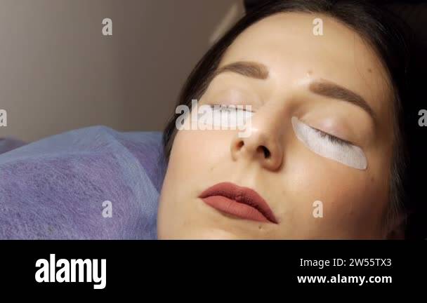 Modern eyelash lamination procedure in a professional beauty salon. The ...