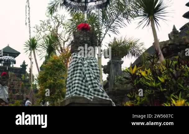 An old Indonesian ethnic stone statue of an evil demon with an open ...